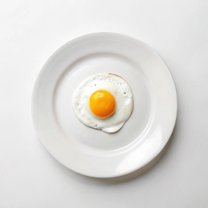 a white plate on fried egg on white background - Recraft